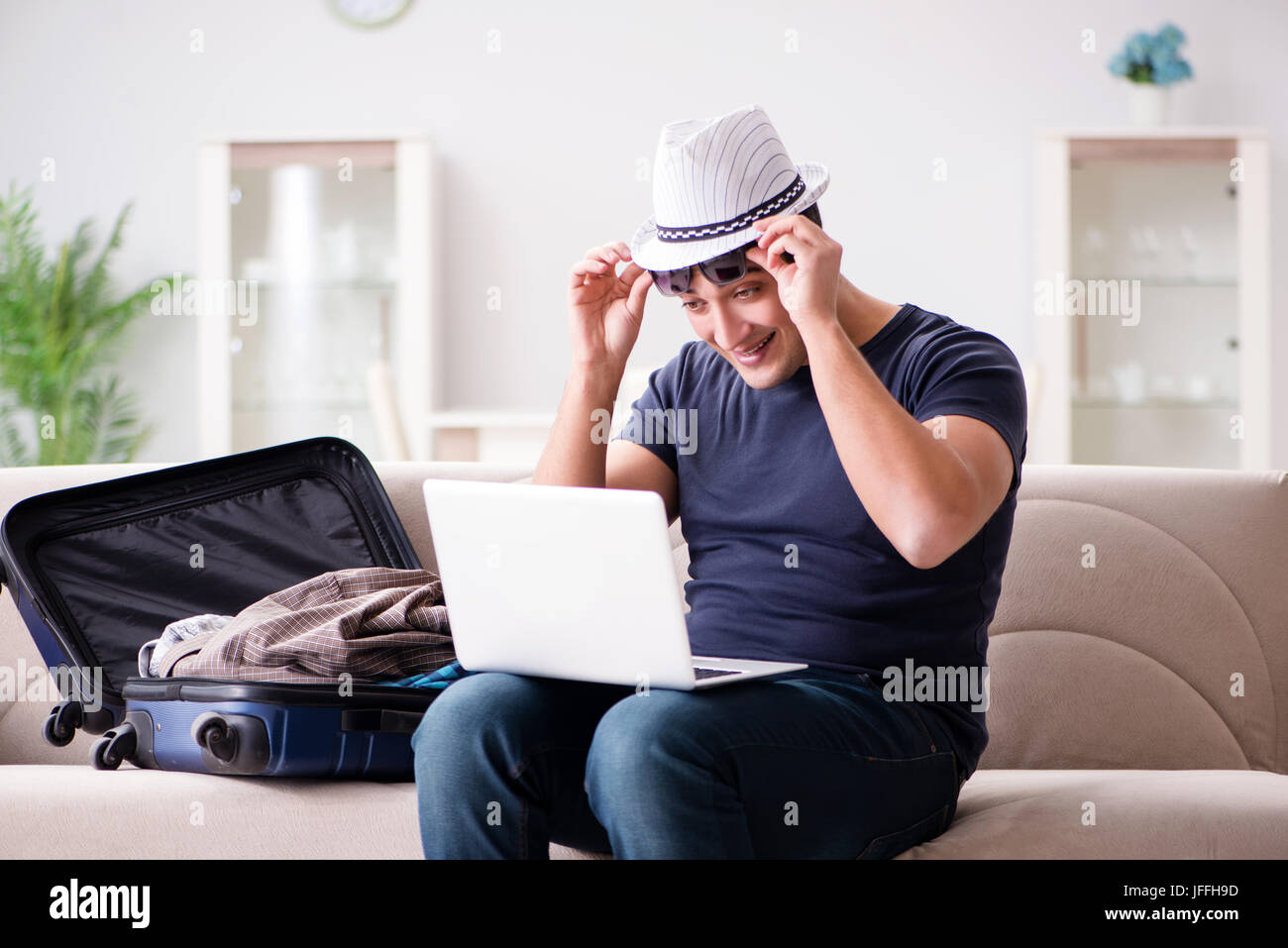Man going on vacation packing his suitcase Stock Photo - Alamy