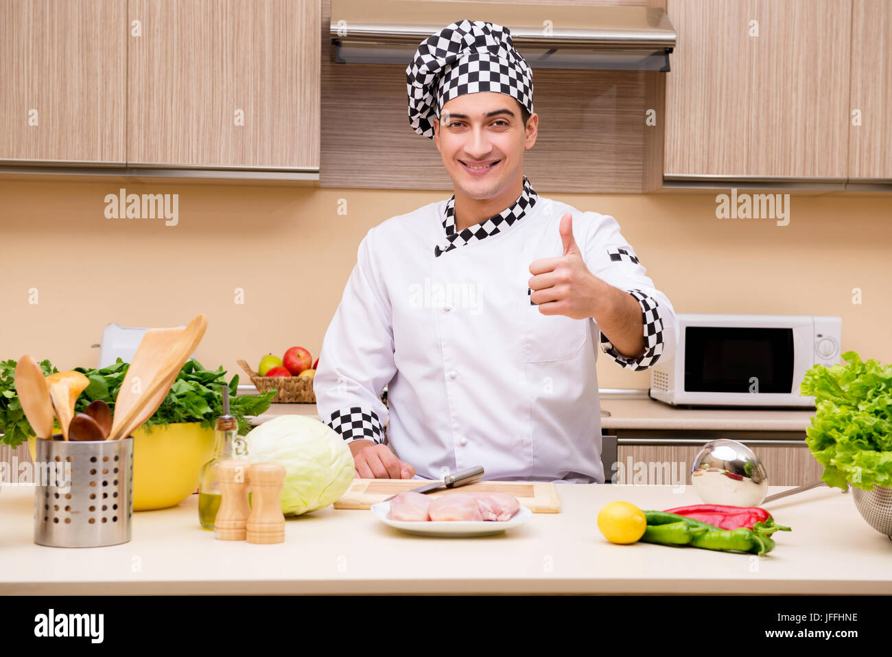 Young chef working in the kitchen Stock Photo - Alamy