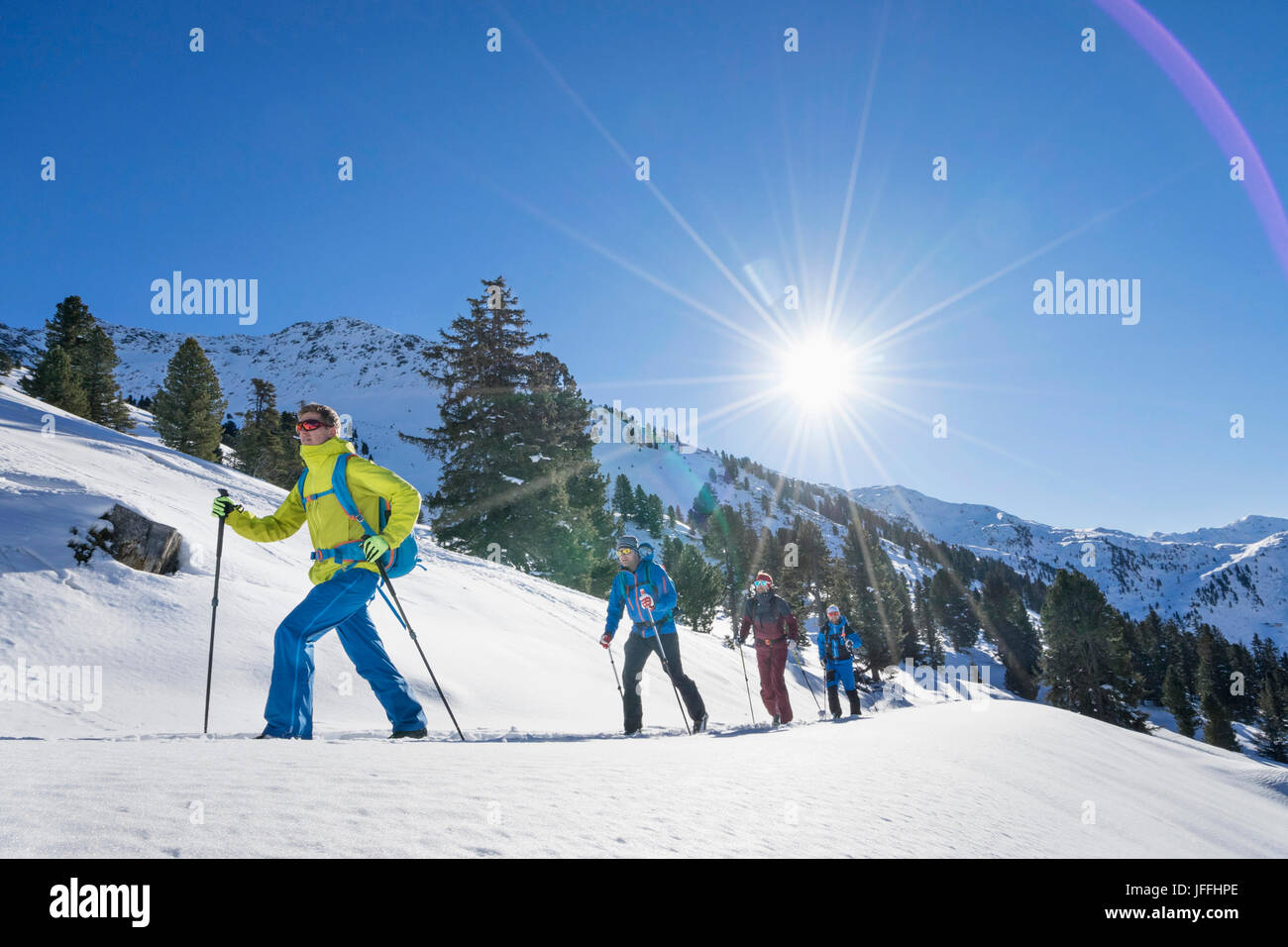 Skiers climbing snow mountain Stock Photo - Alamy