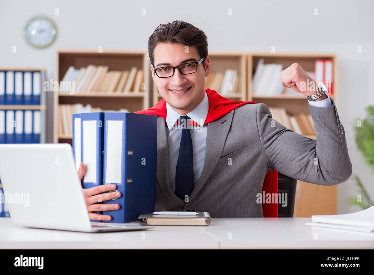 Superhero businessman working in the office Stock Photo - Alamy