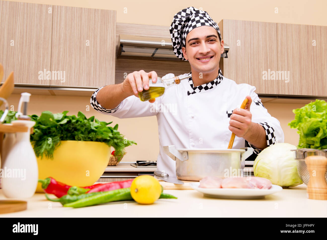 Young chef working in the kitchen Stock Photo - Alamy