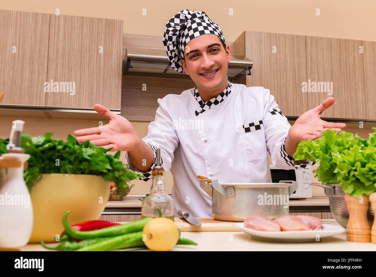 Young chef working in the kitchen Stock Photo - Alamy