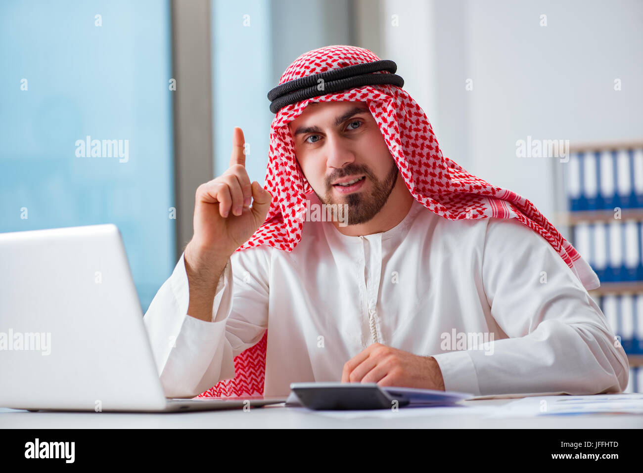 Arab businessman working on laptop computer Stock Photo - Alamy