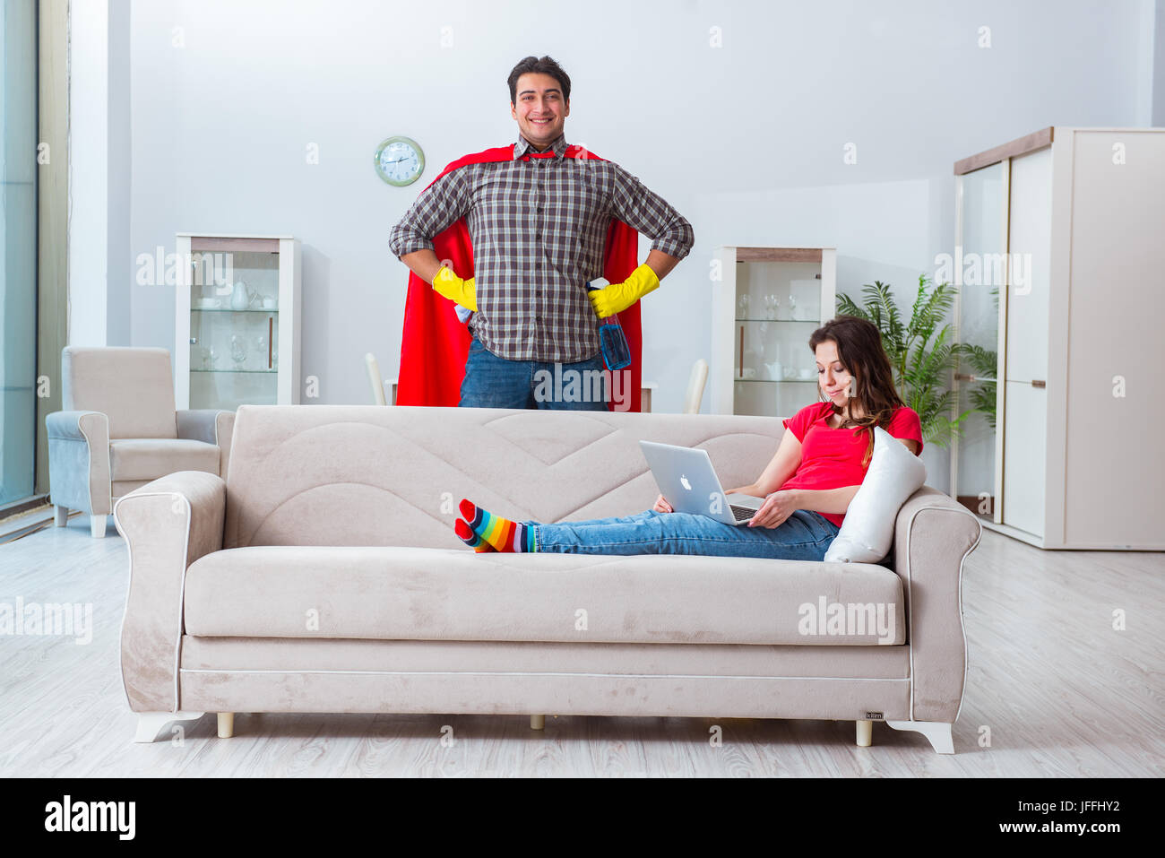 Superhero husband helping his wife at home Stock Photo - Alamy