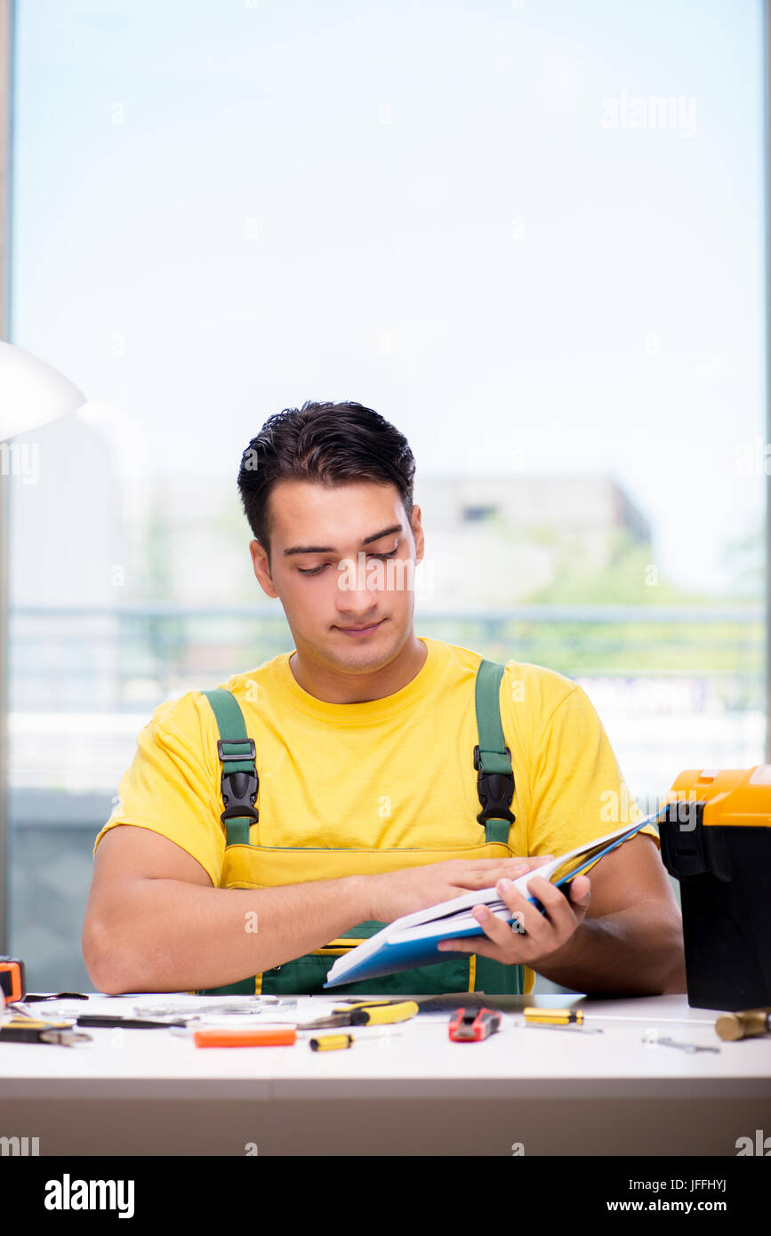 Construction worker sitting at the desk Stock Photo - Alamy
