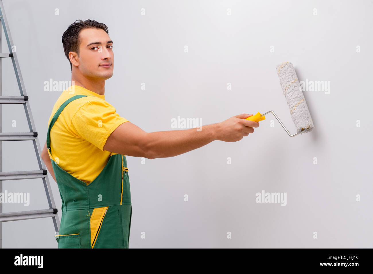 Man painting the wall in DIY concept Stock Photo - Alamy