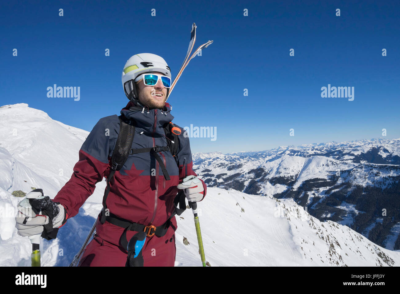 Skier standing on snow mountain Stock Photo - Alamy