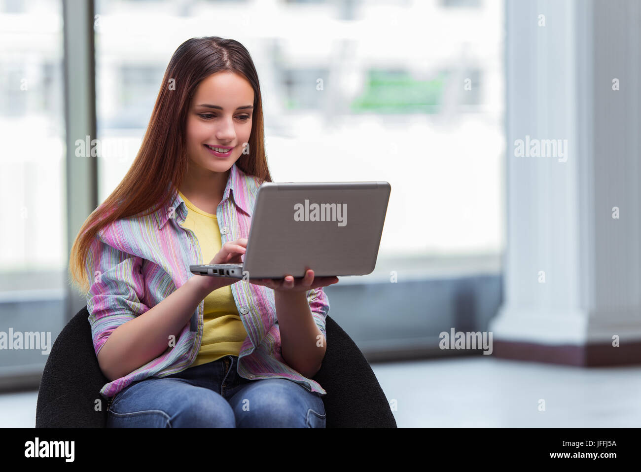 Young girl surfing internet on laptop Stock Photo - Alamy