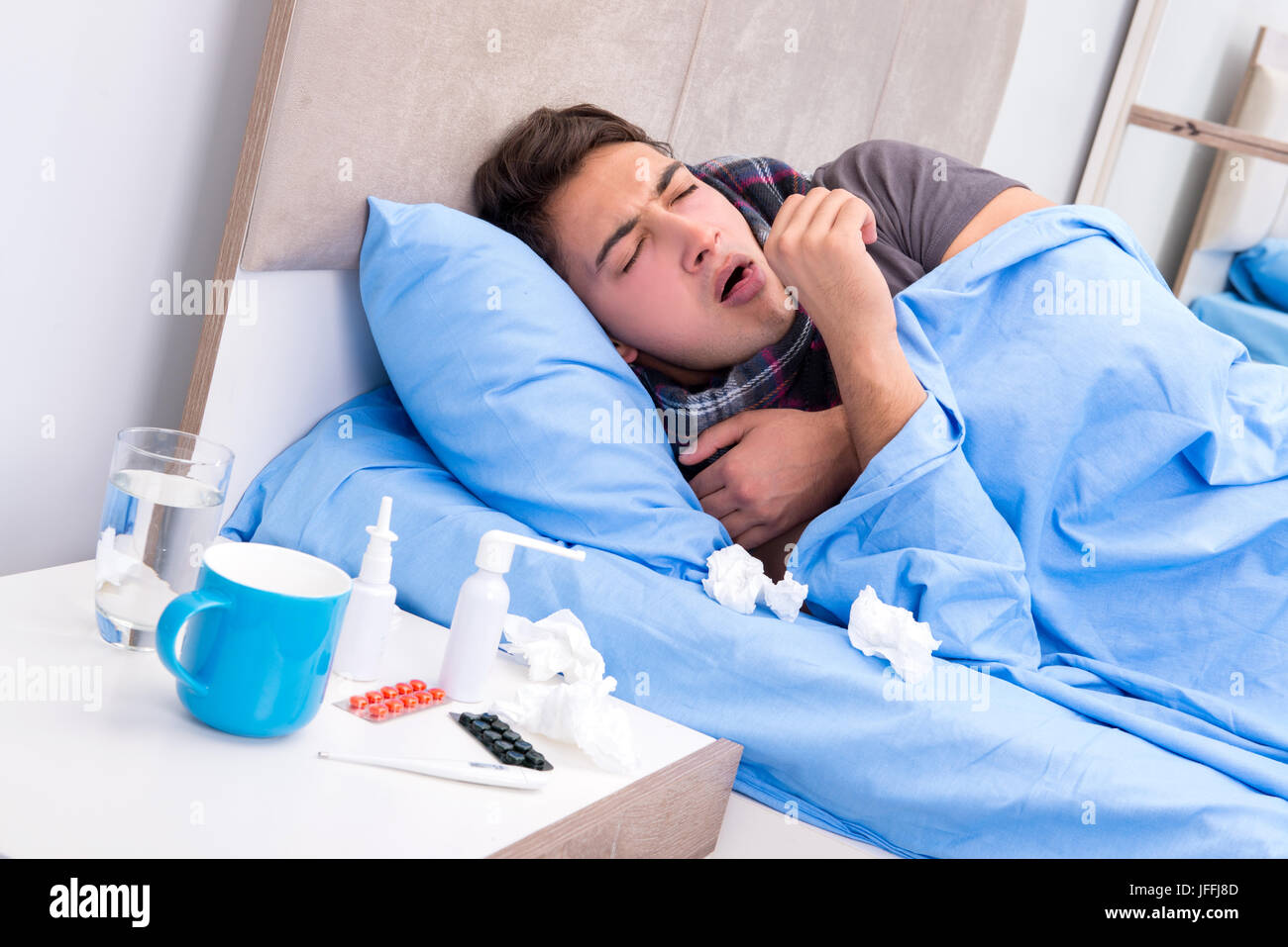Sick man with flu lying in the bed Stock Photo - Alamy