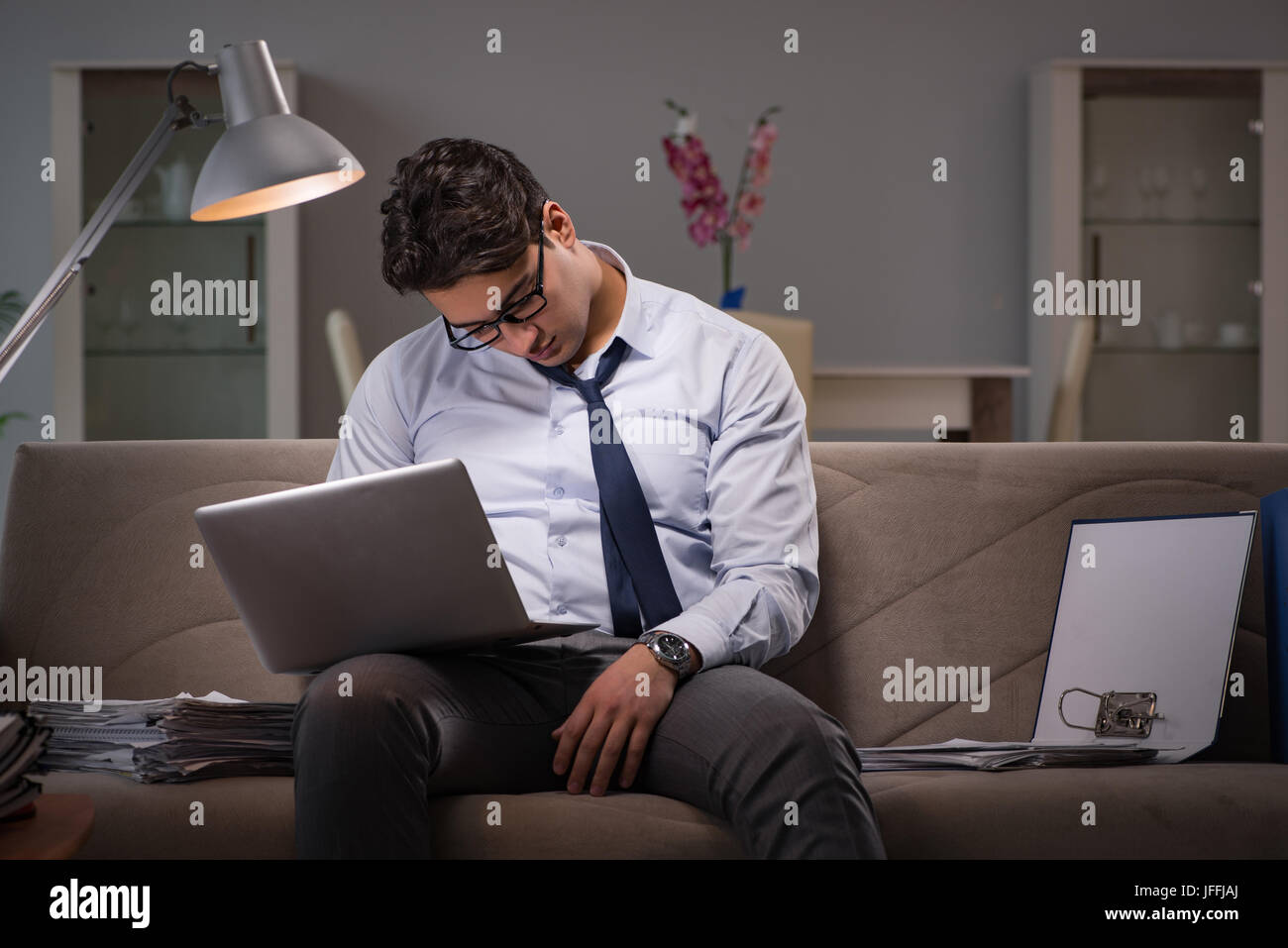 Businessman workaholic working late at home Stock Photo - Alamy