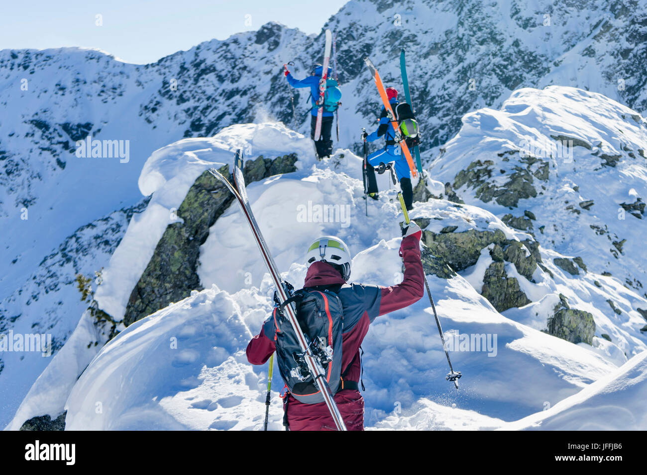 Rear view of skiers climbing on snow mountain Stock Photo - Alamy