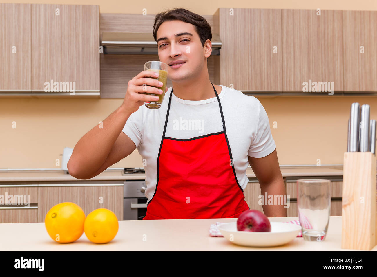 Handsome man working at the kitchen Stock Photo - Alamy