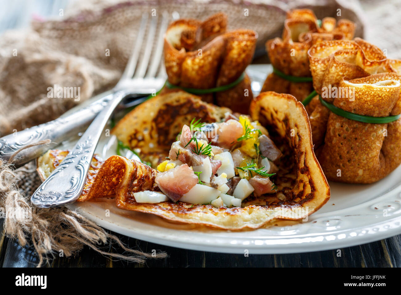 Crepes stuffed with herring, egg and green onions Stock Photo - Alamy