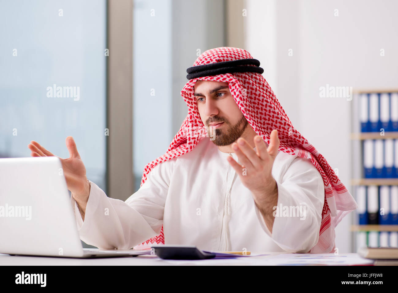 Arab businessman working on laptop computer Stock Photo - Alamy