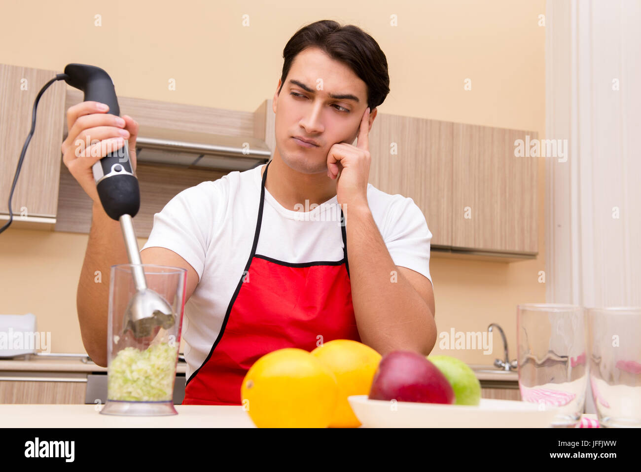 Handsome man working at the kitchen Stock Photo - Alamy