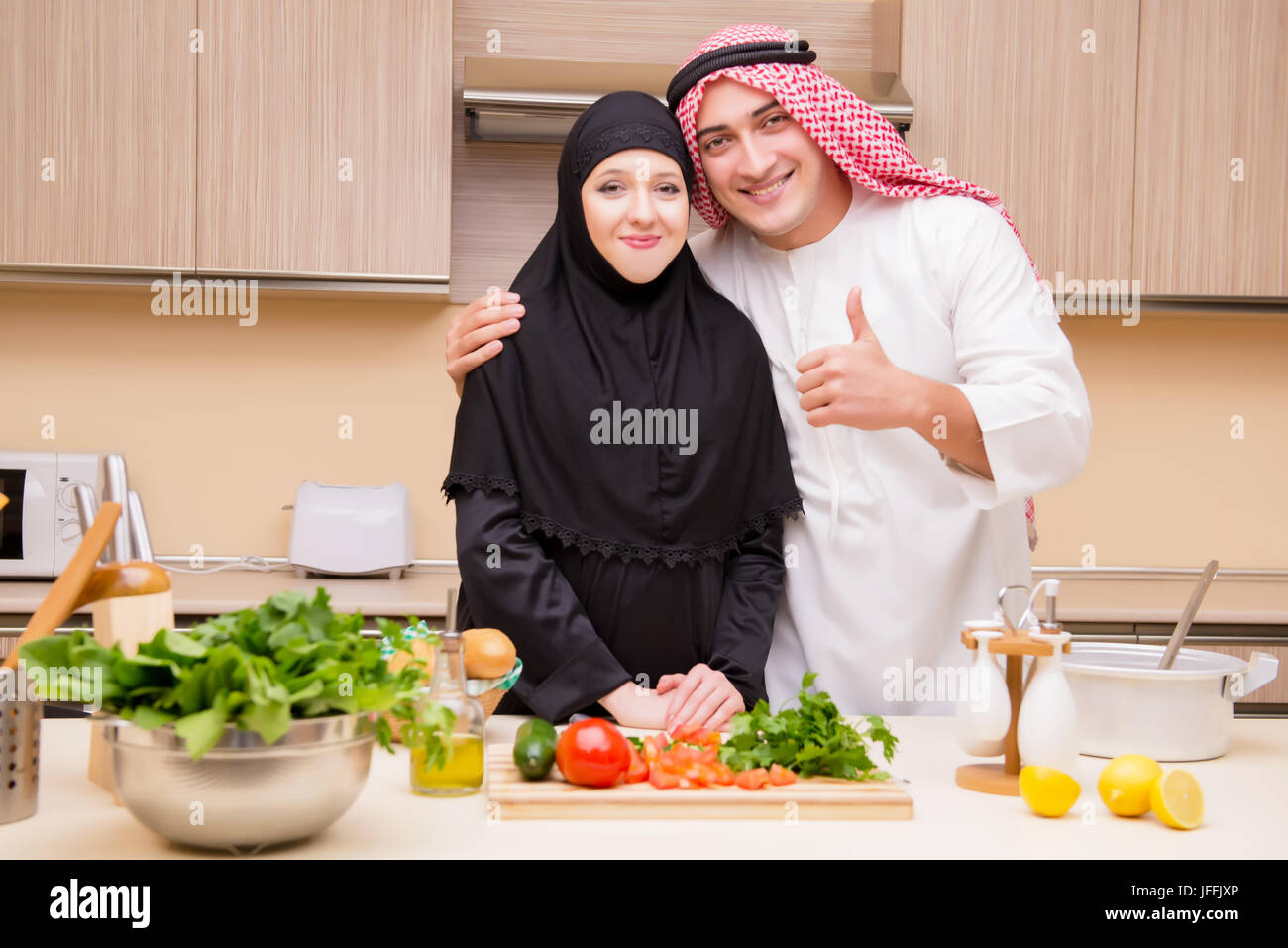 Young arab family in the kitchen Stock Photo - Alamy