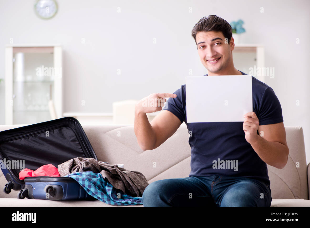 Man going on vacation packing his suitcase Stock Photo - Alamy