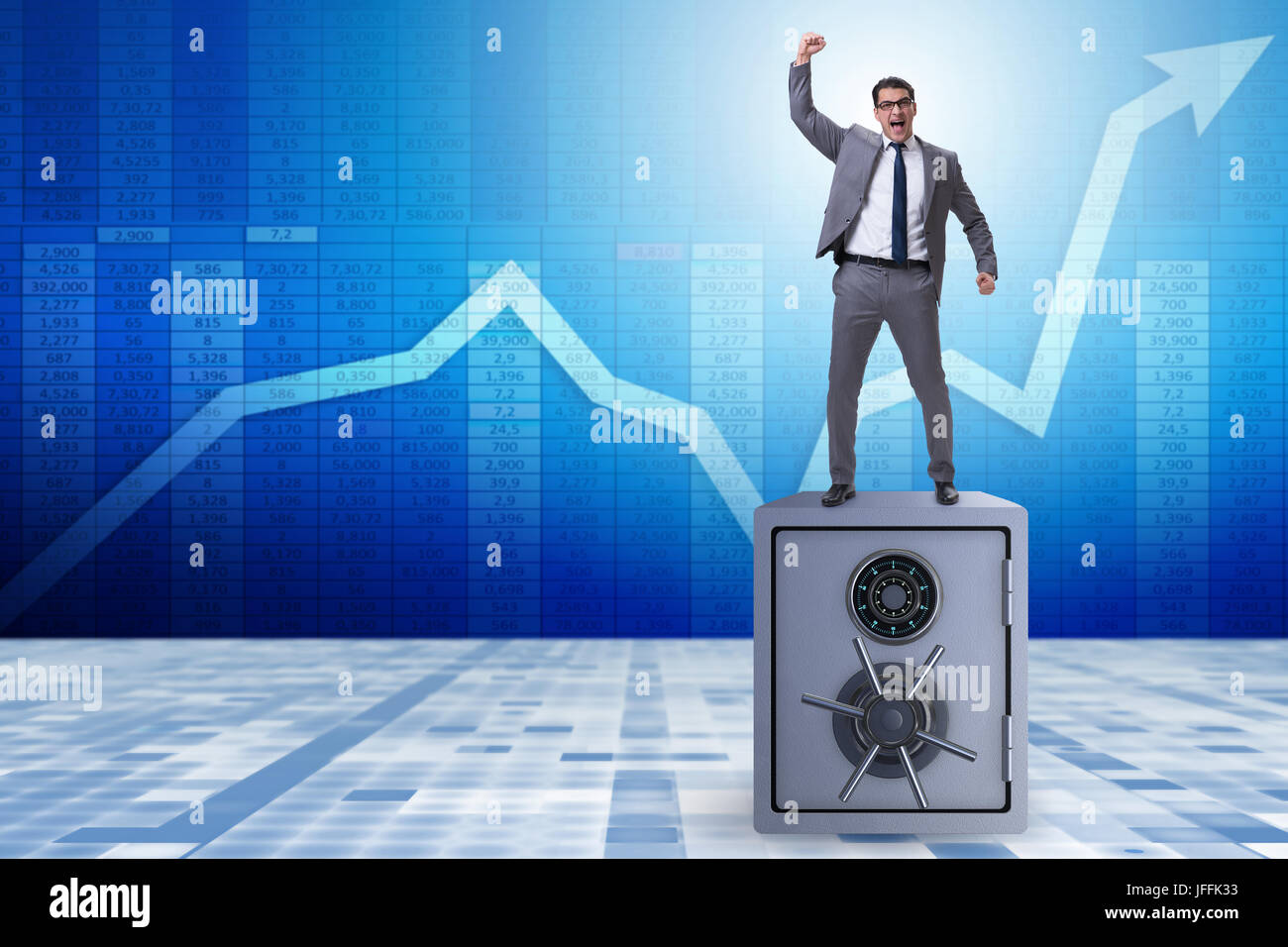 Excited businessman standing on top of safe Stock Photo - Alamy