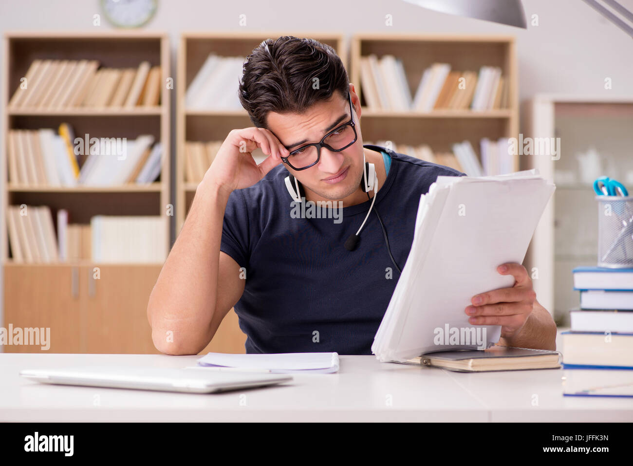 Unhappy student with too much to study Stock Photo - Alamy