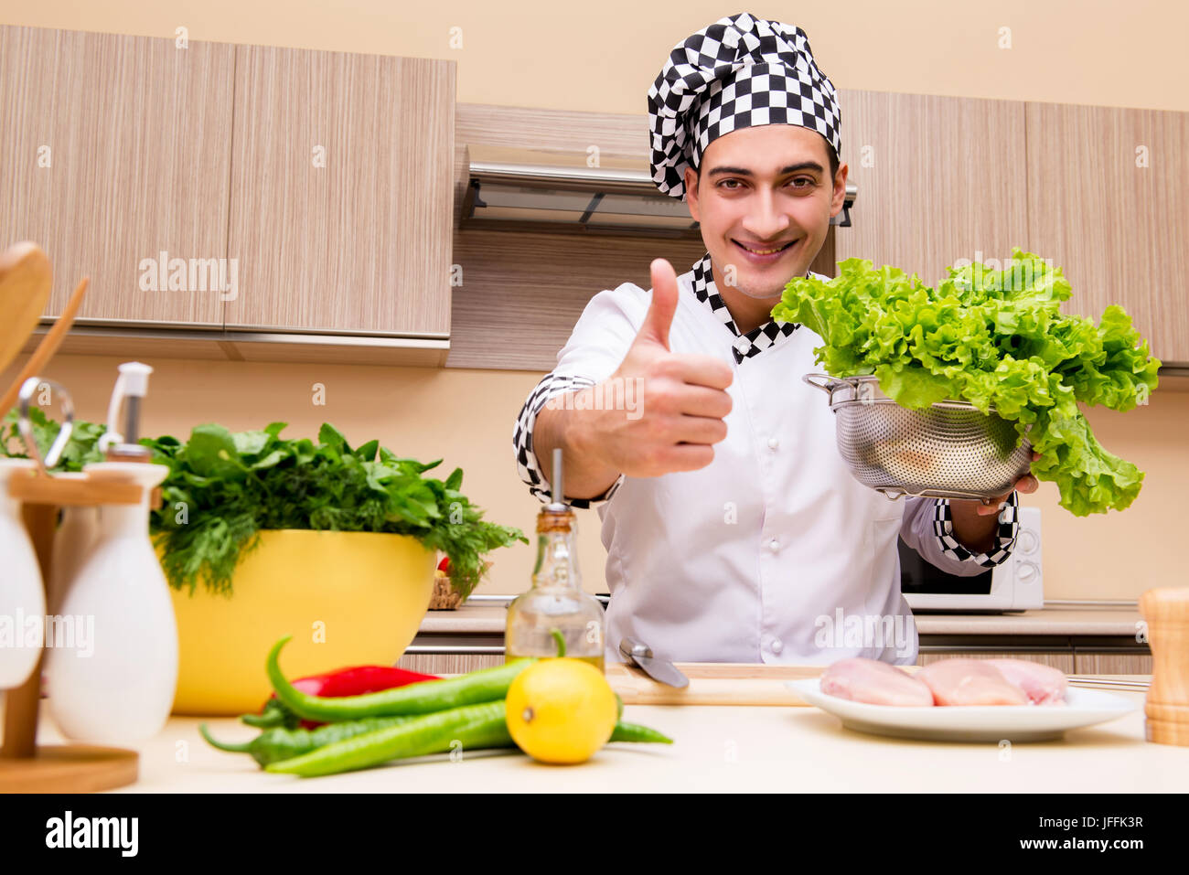 Young chef working in the kitchen Stock Photo - Alamy