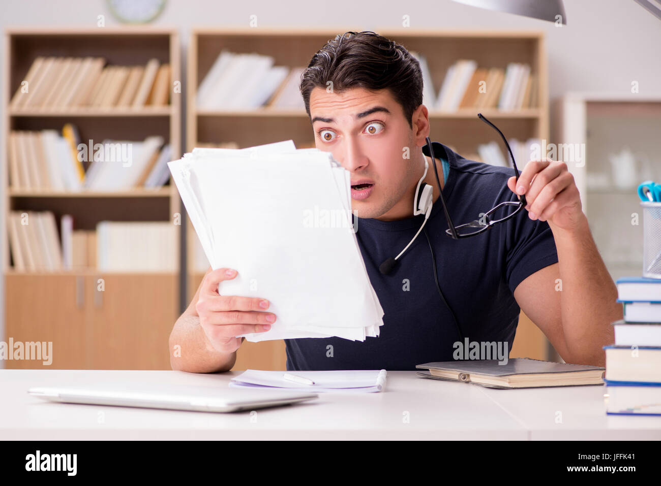 Angry man with too much paperwork to do Stock Photo - Alamy