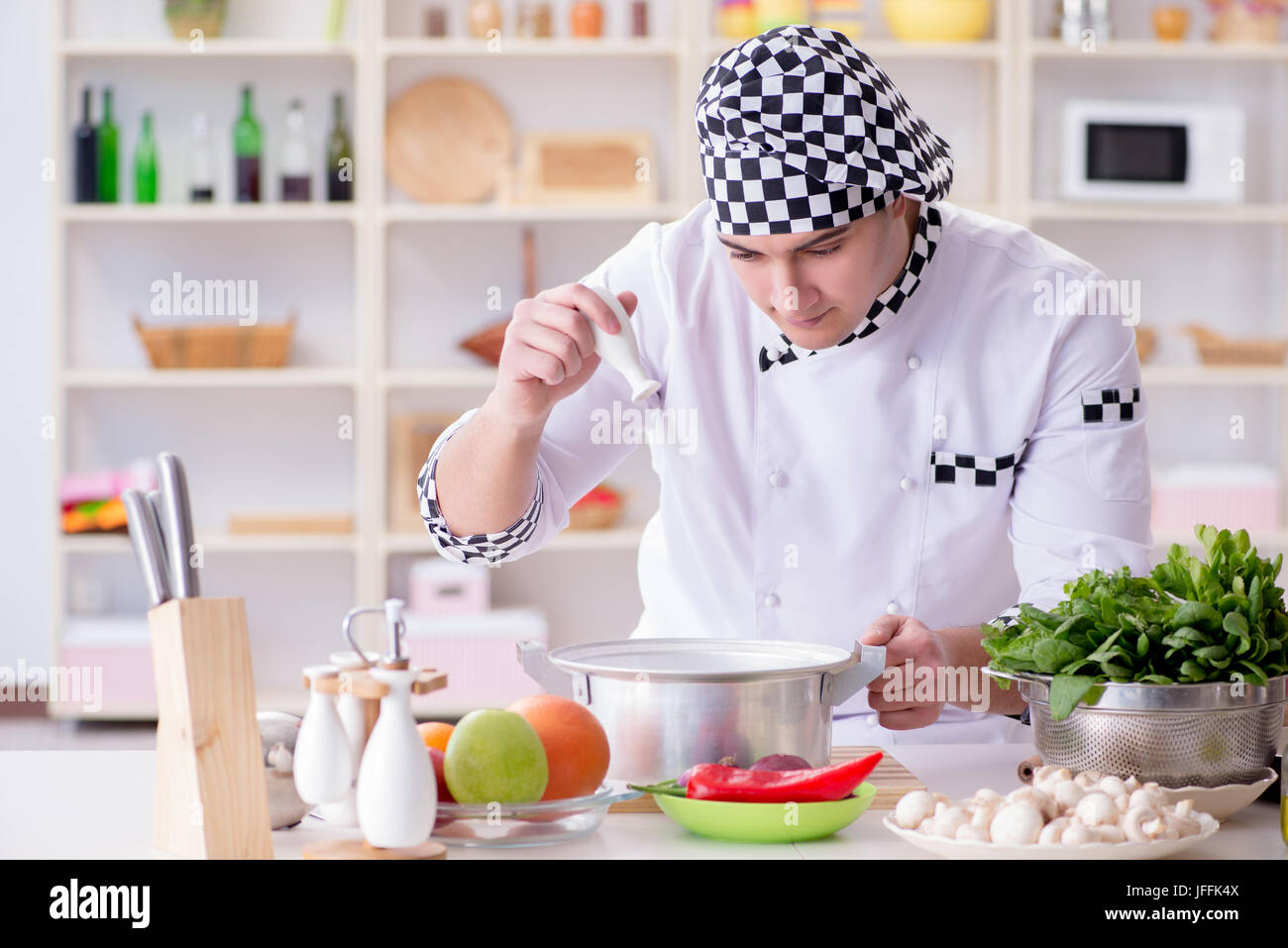 Young male cook working in the kitchen Stock Photo - Alamy