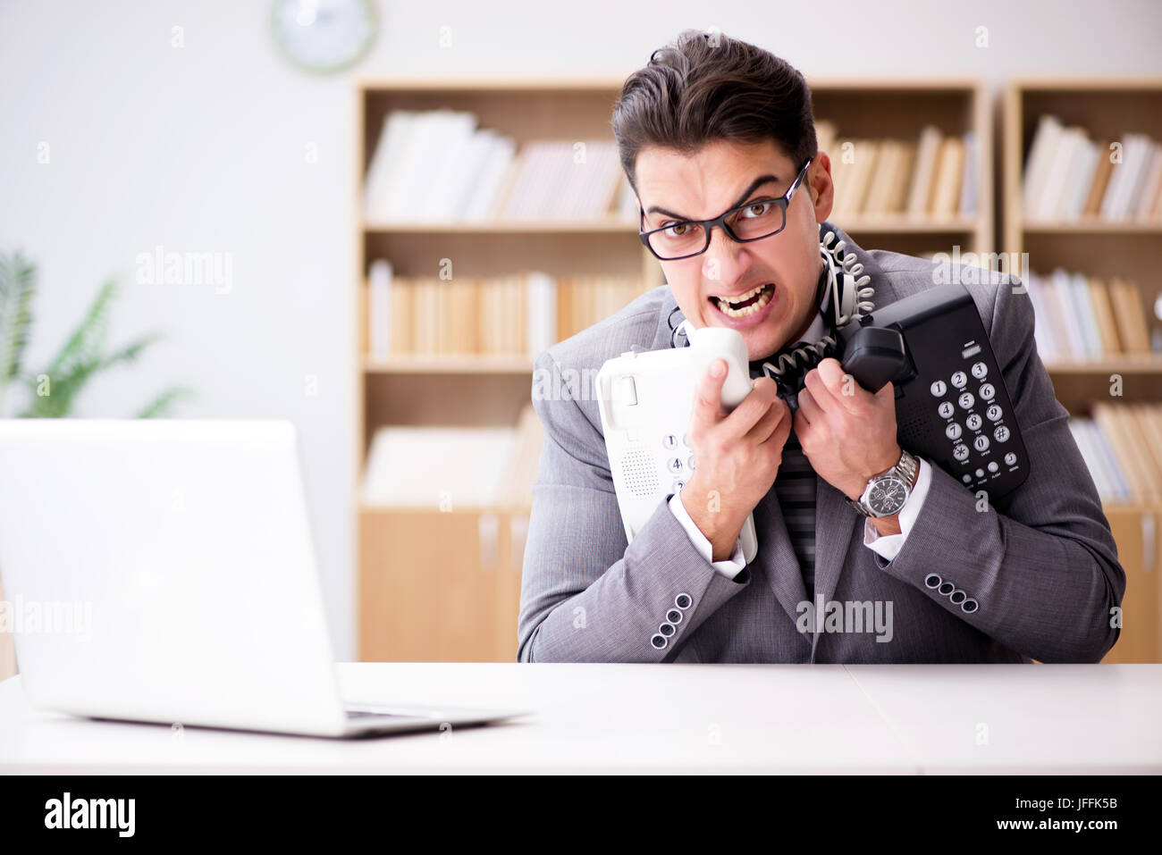 Angry helpdesk operator yelling in office Stock Photo - Alamy