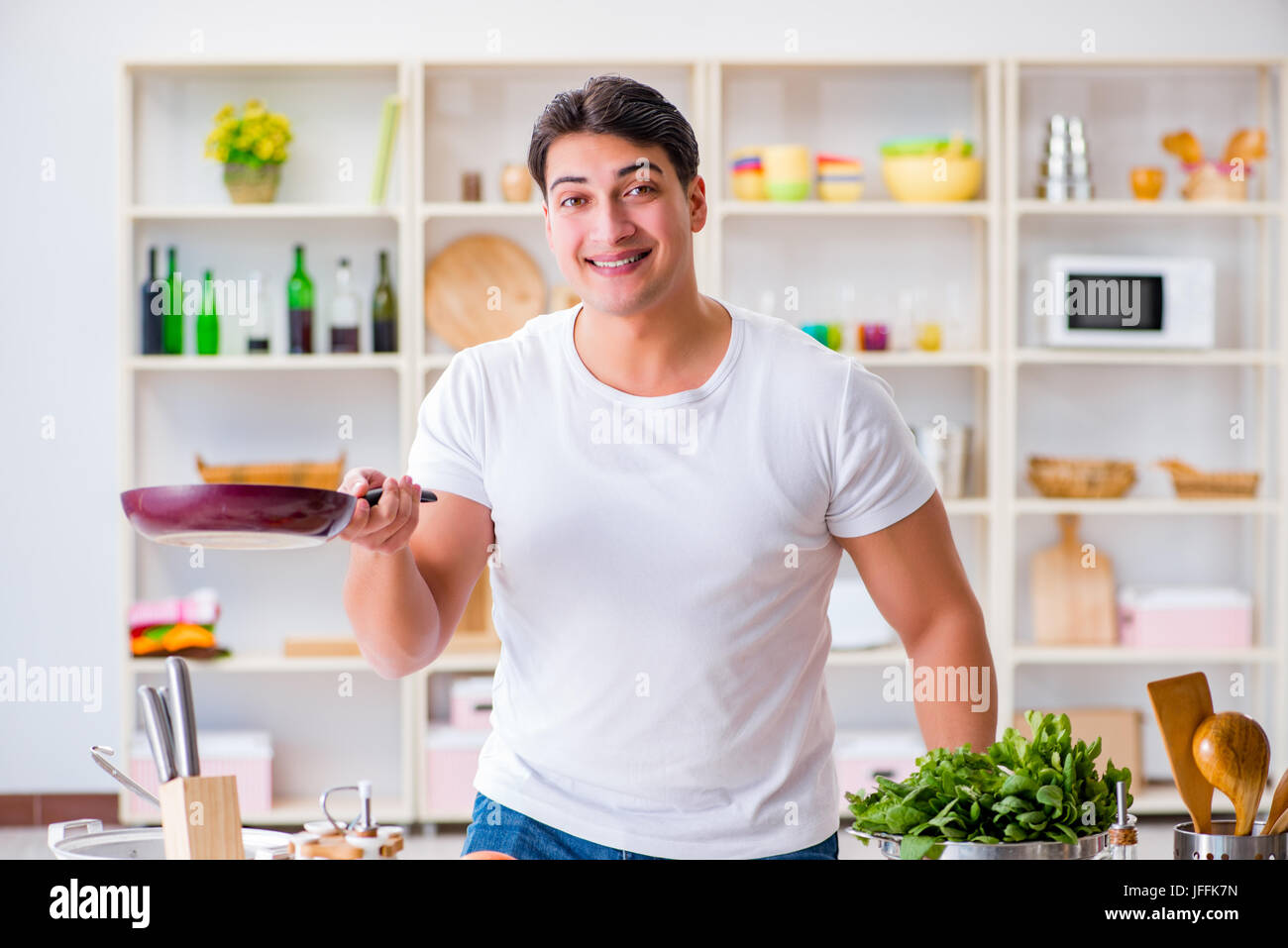 Young male cook working in the kitchen Stock Photo - Alamy
