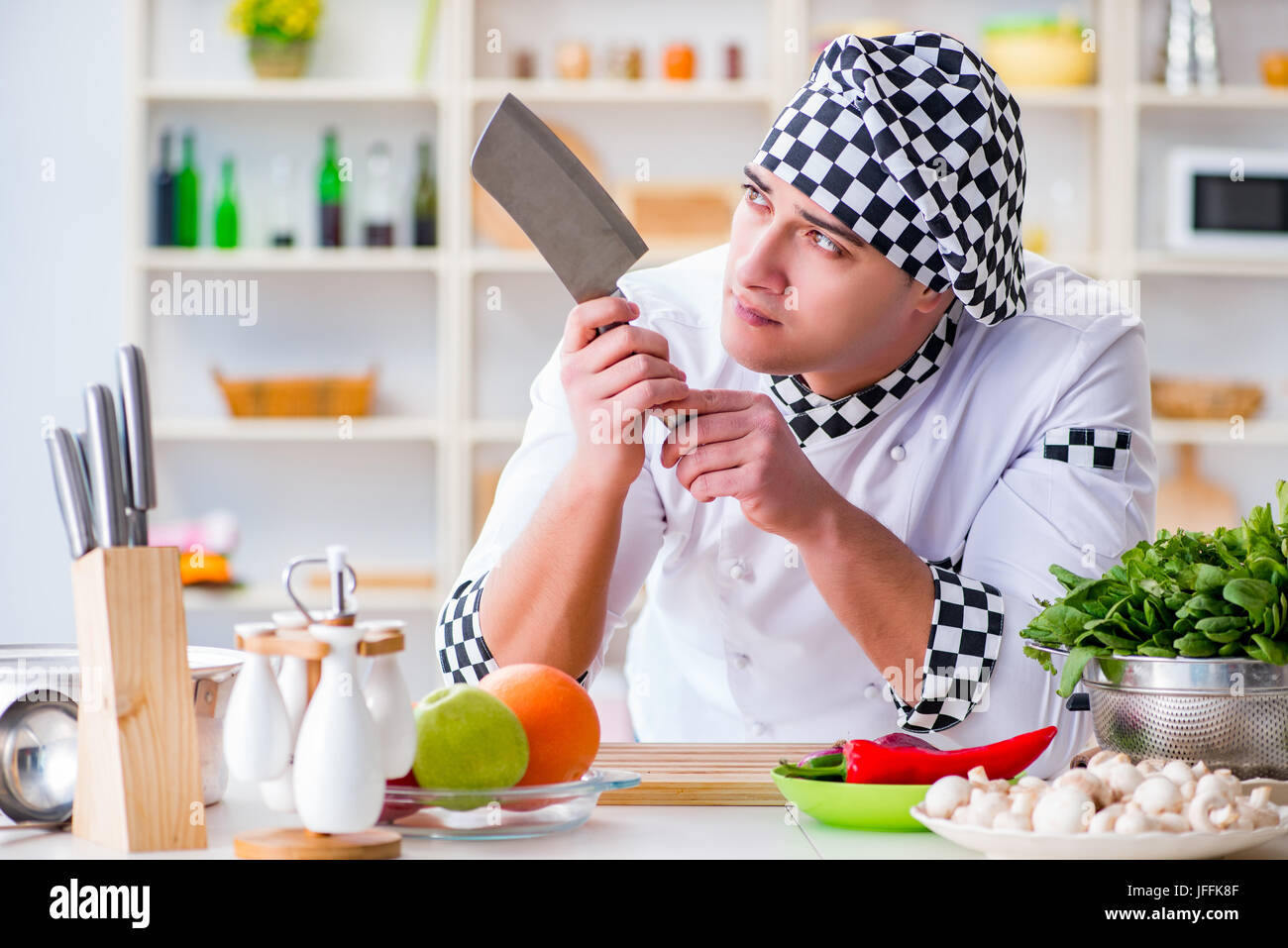 Young male cook working in the kitchen Stock Photo - Alamy