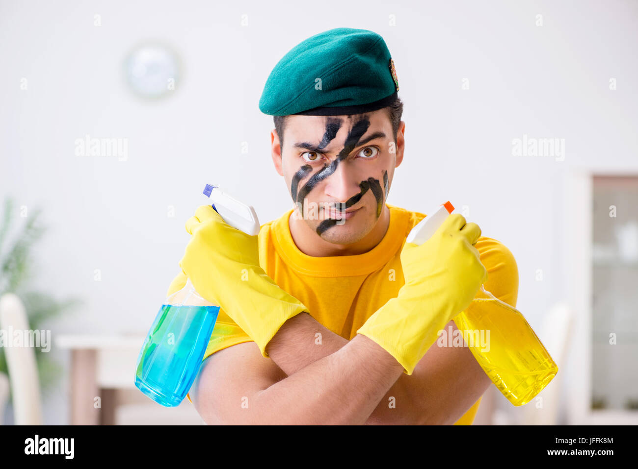 Man in military style cleaning the house Stock Photo - Alamy