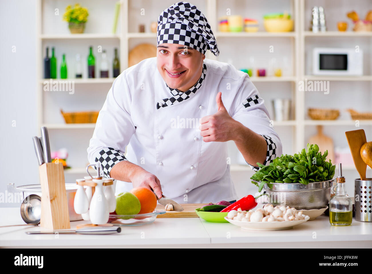 Young male cook working in the kitchen Stock Photo - Alamy