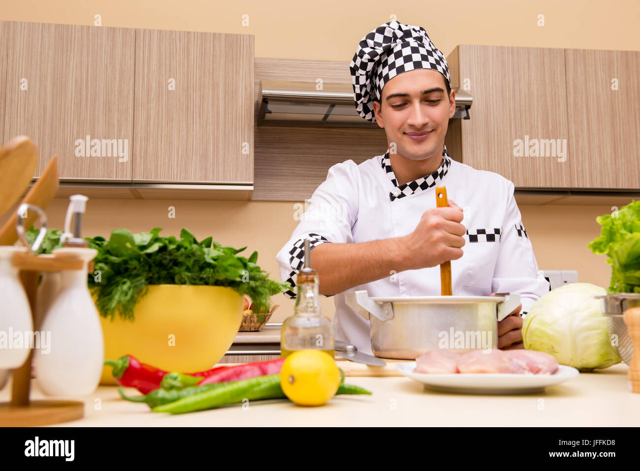 Young chef working in the kitchen Stock Photo - Alamy