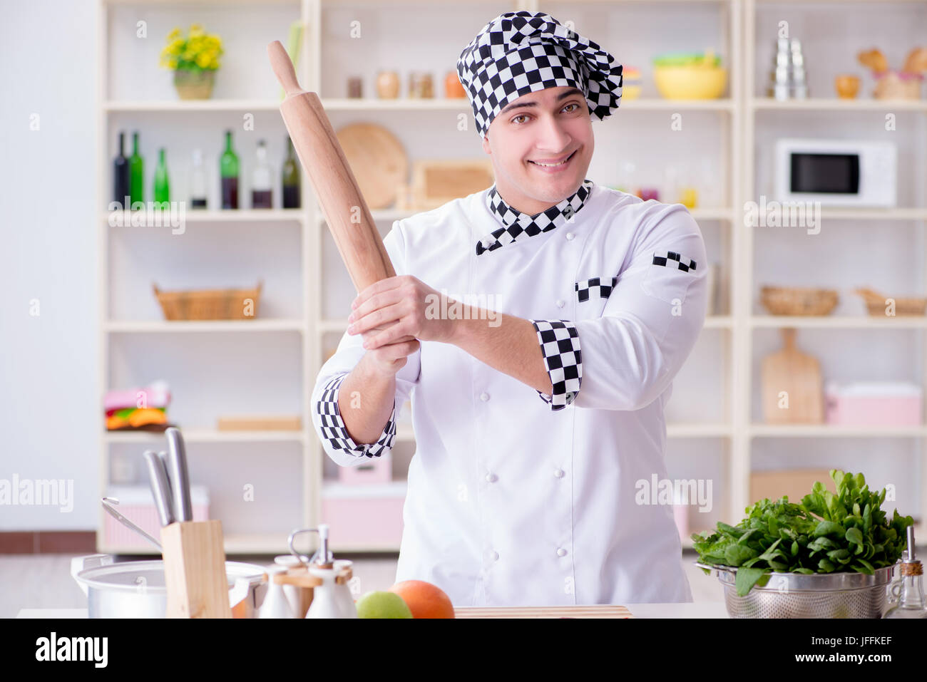 Young male cook working in the kitchen Stock Photo - Alamy