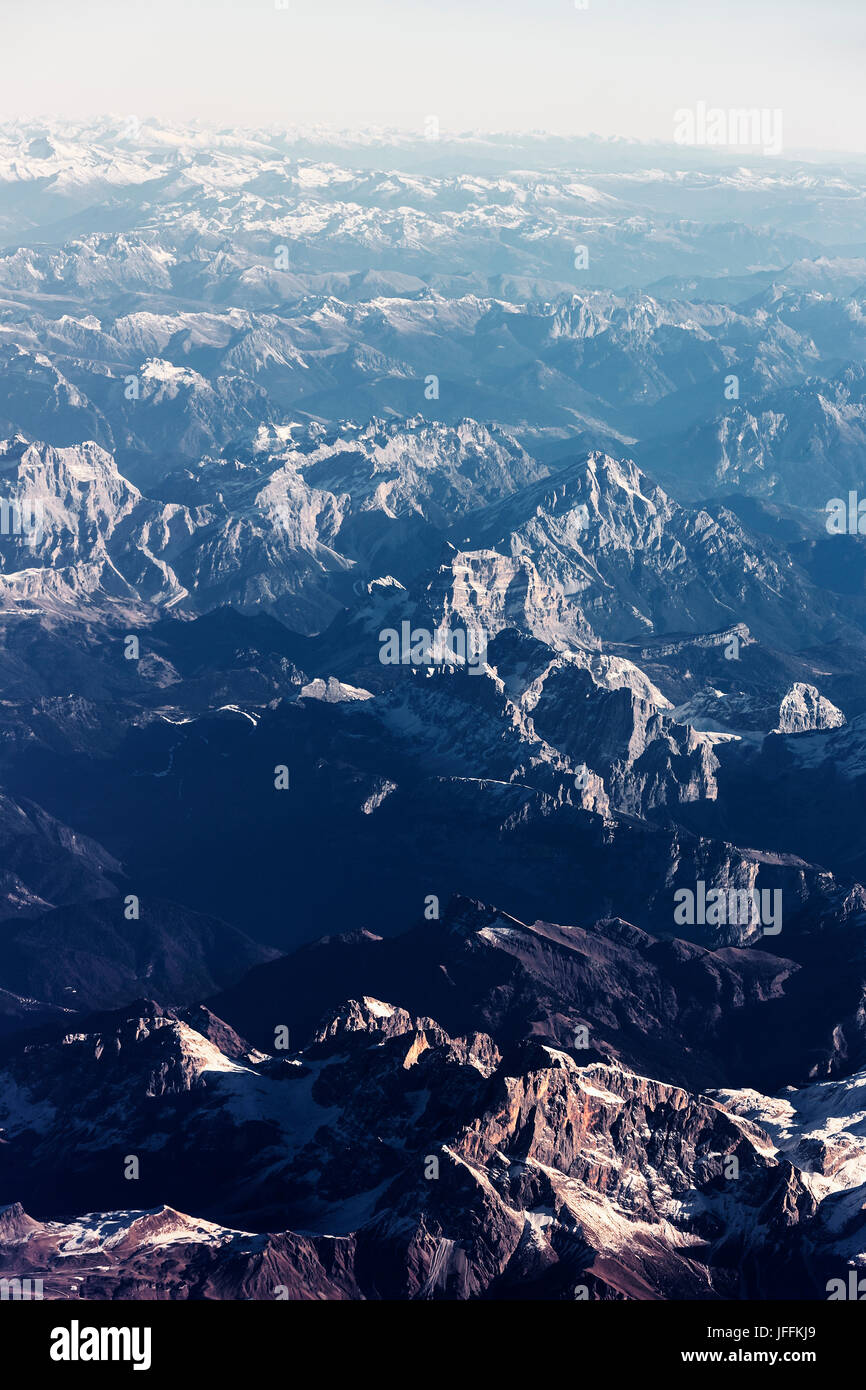 Aerial view of rocky mountain range covered with snow Stock Photo - Alamy
