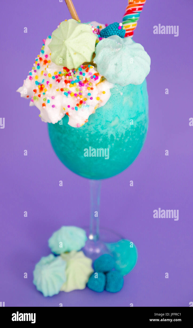 Delicious homemade extreme milkshake with dragees over a milk foam and ...