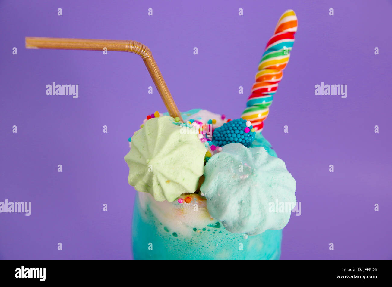 Delicious homemade extreme milkshake with dragees over a milk foam and ...