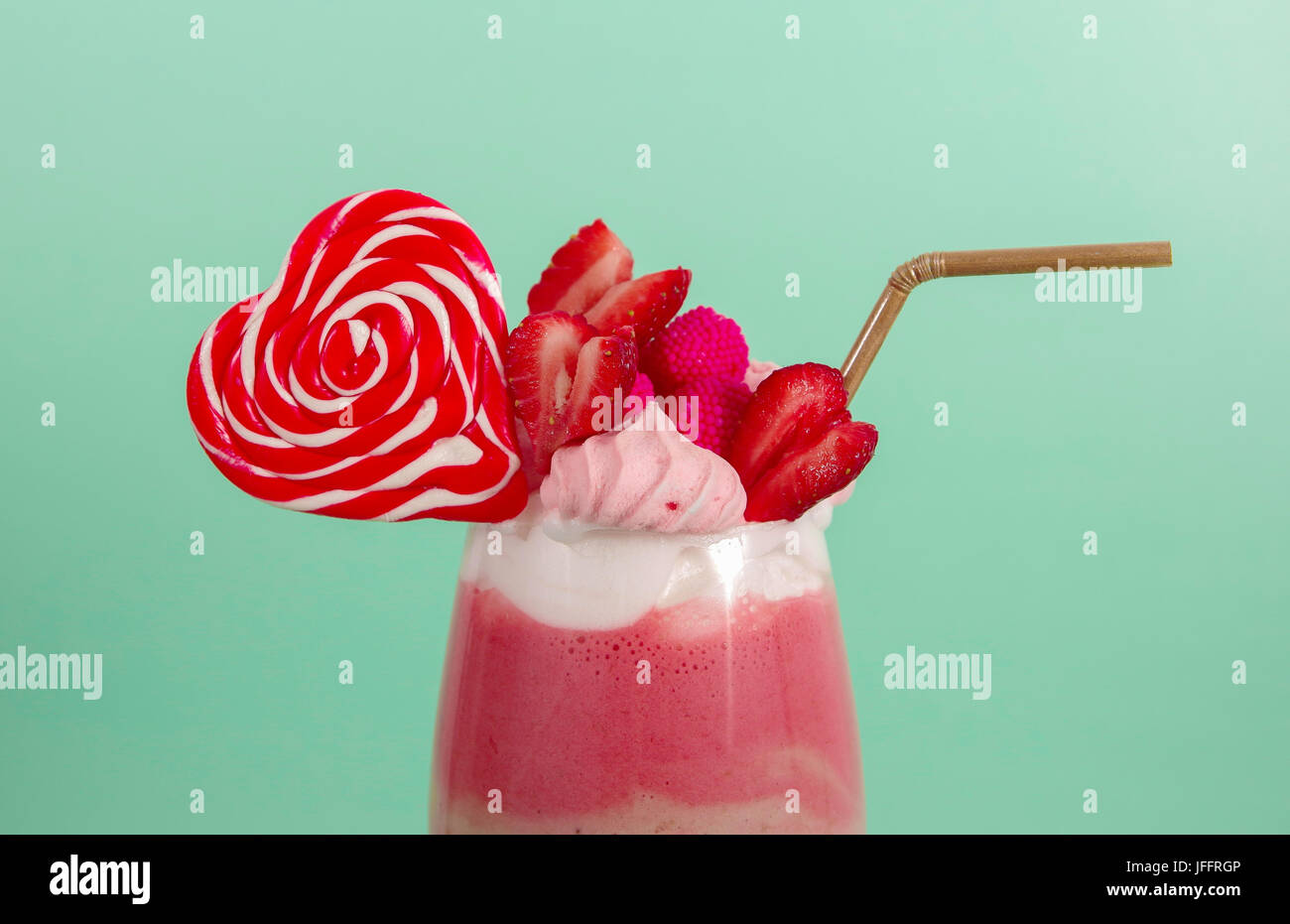 Close up of a delicious homemade extreme milkshake of strawberry with ...