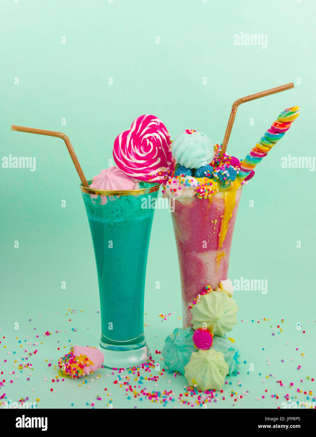 Two elicious homemade extreme milkshake, with a blackberry candy over a milk foam and a rainbow ...