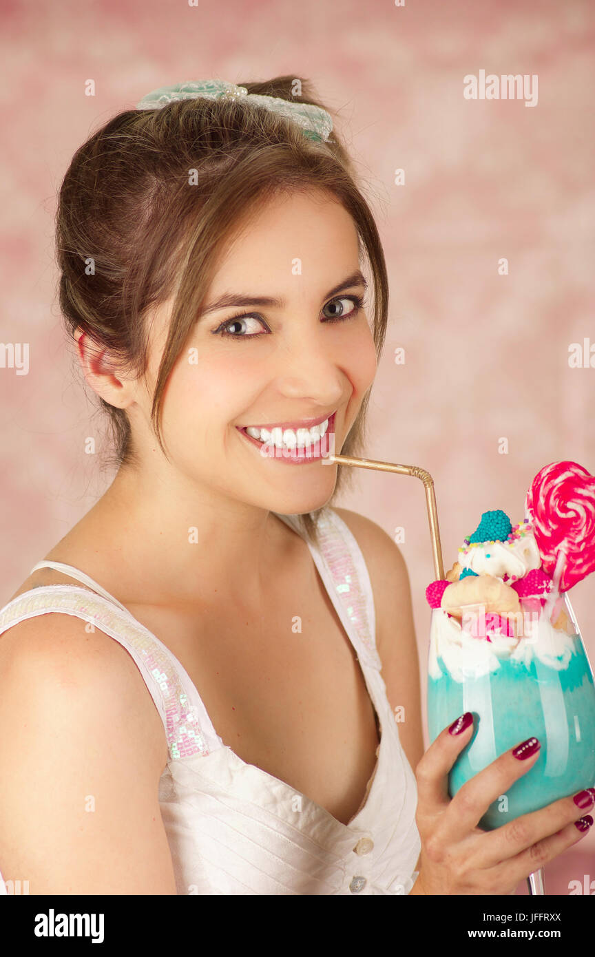 Indoor portrait of pretty cute smiling woman drinking tasty blue milk ...