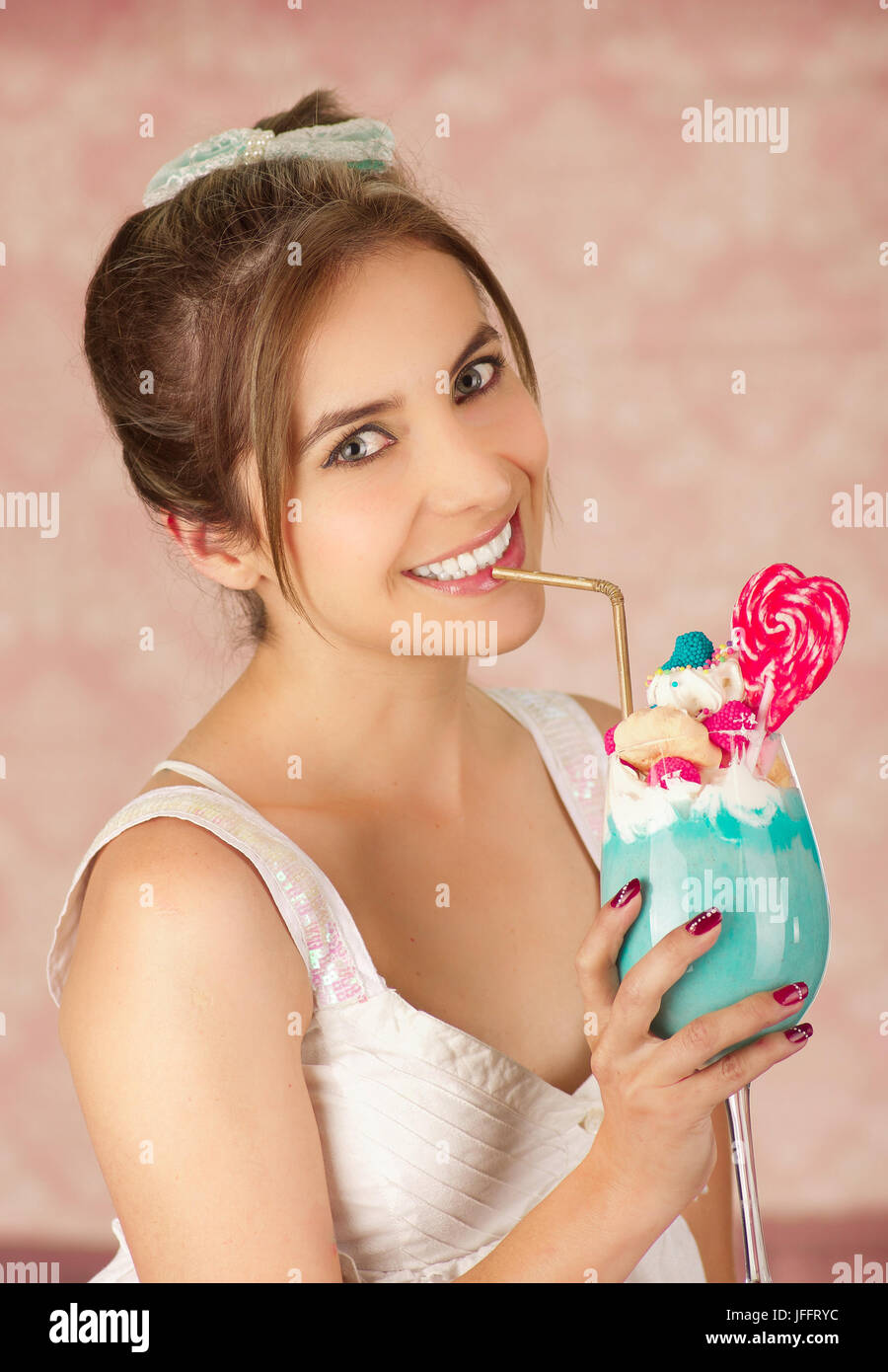 Indoor portrait of pretty cute smiling woman drinking tasty blue milk ...