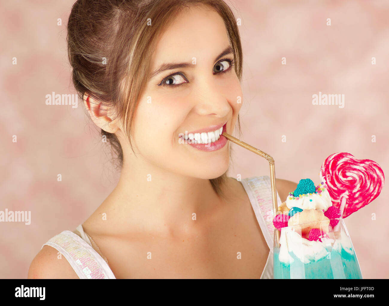 Indoor portrait of pretty cute smiling woman drinking tasty blue milk ...