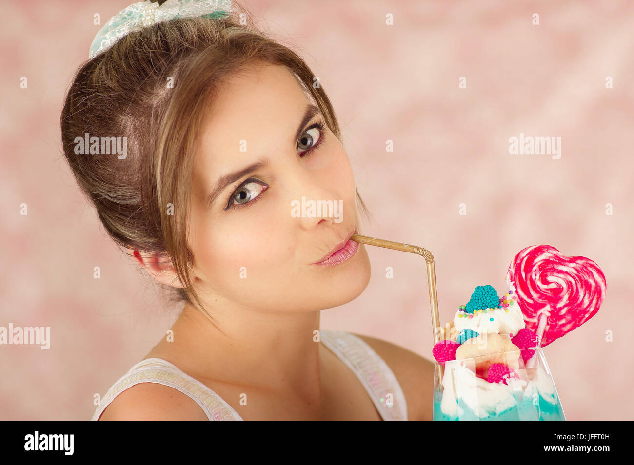 Beautiful woman drinking pink milkshake hi-res stock photography and ...
