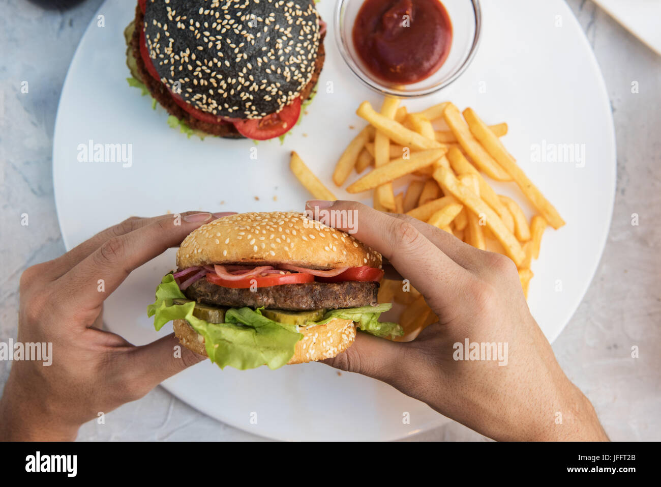 Man eating burgers Stock Photo - Alamy