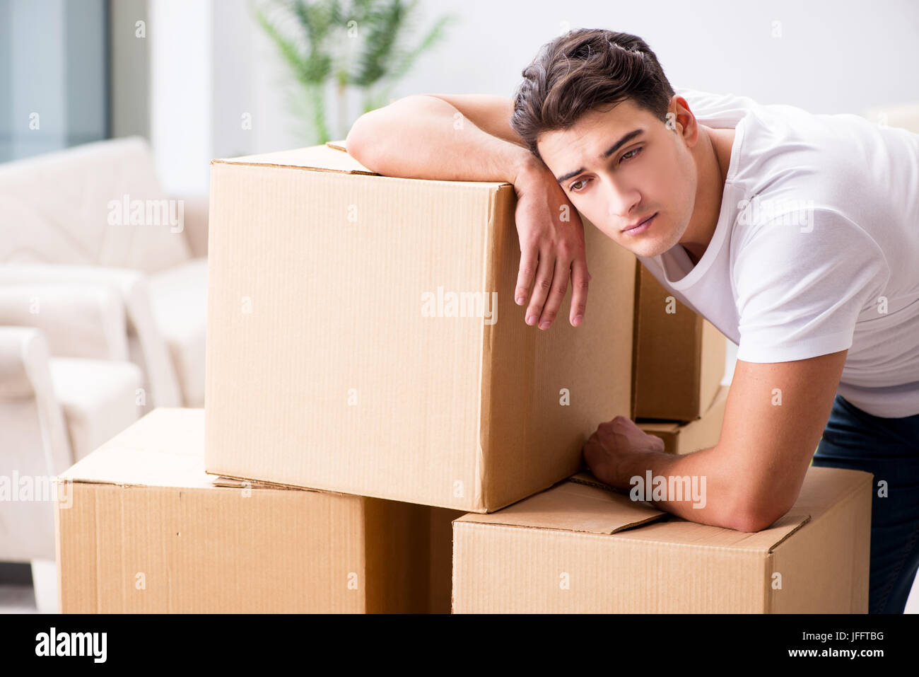 Young man moving boxes at home Stock Photo - Alamy