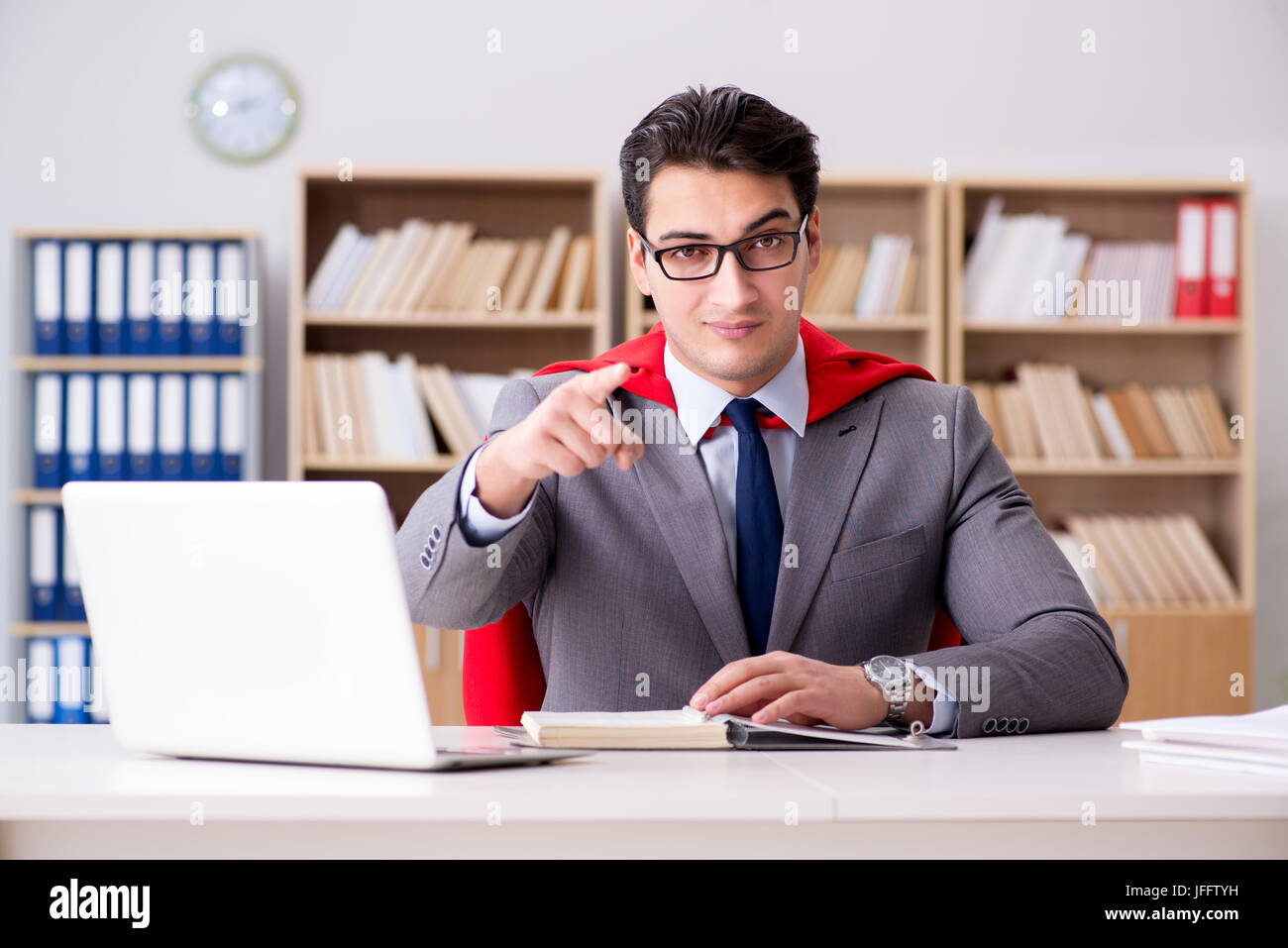 Superhero businessman working in the office Stock Photo - Alamy