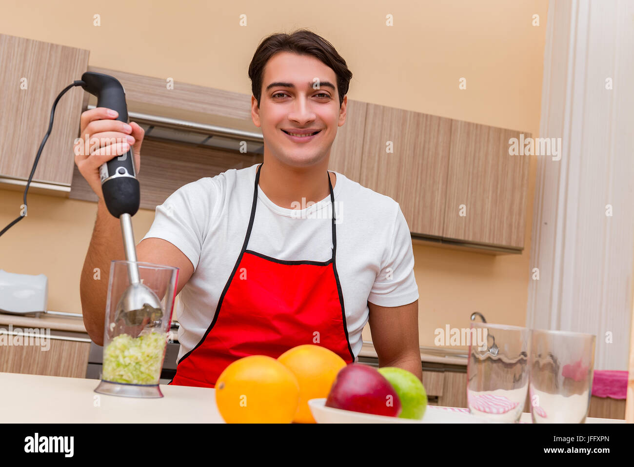 Handsome man working at the kitchen Stock Photo - Alamy