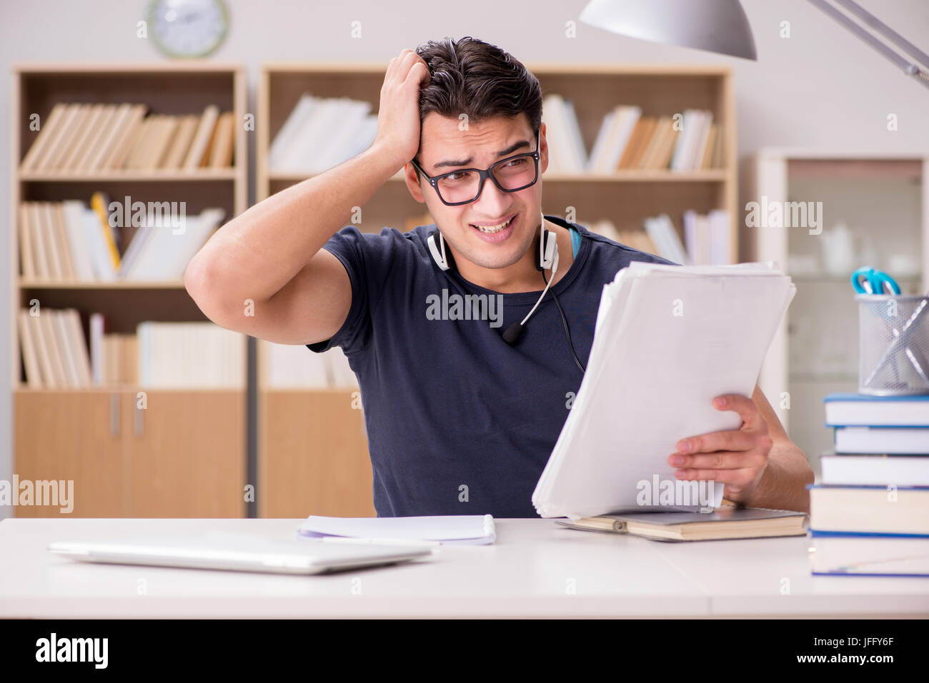Unhappy student with too much to study Stock Photo - Alamy