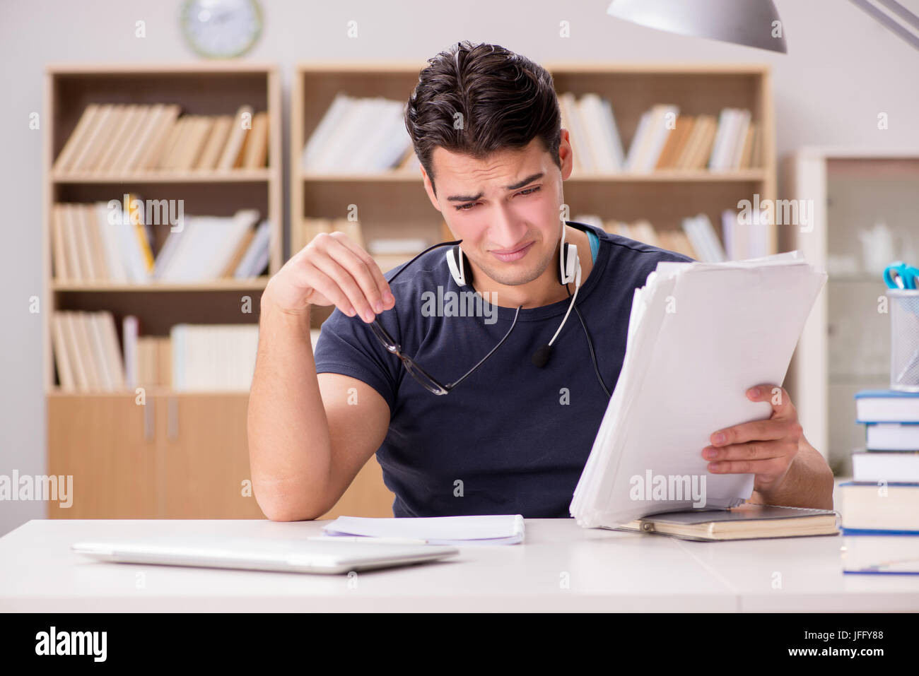 Unhappy student with too much to study Stock Photo - Alamy