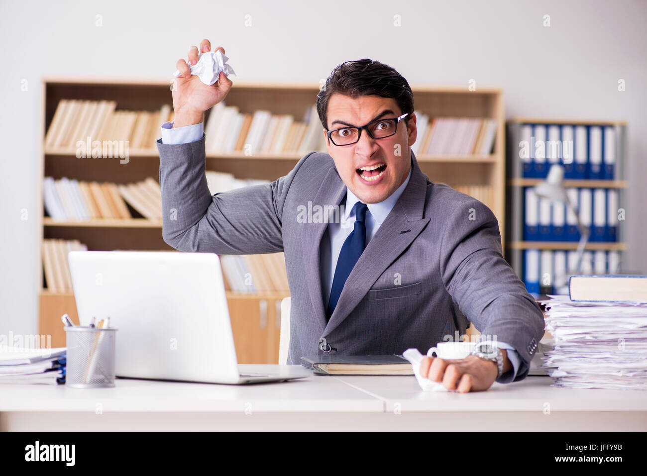 Angry businessman working in the office Stock Photo - Alamy