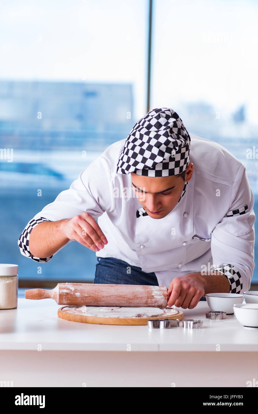Young man cooking cookies in kitchen Stock Photo - Alamy